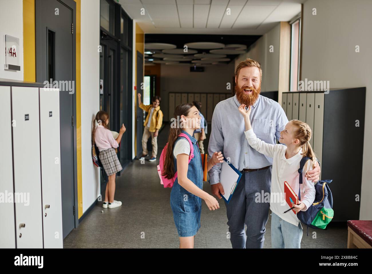 A man with a comforting presence walks down a hallway with children ...