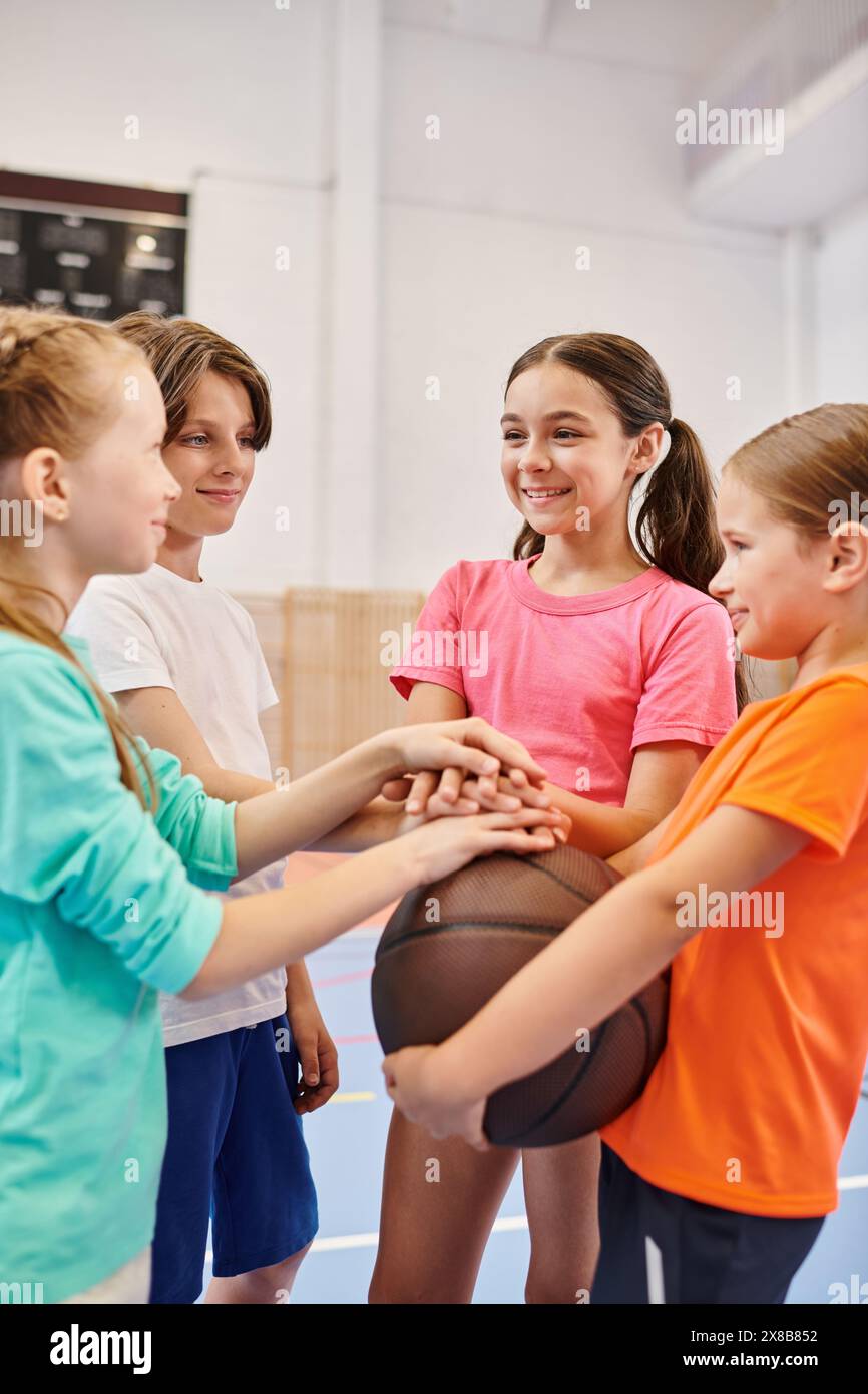A diverse group of young kids stand around a basketball Stock Photo - Alamy