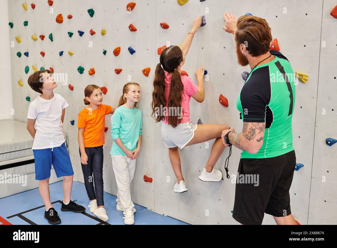 A diverse group of young children stand side by side on a colorful ...
