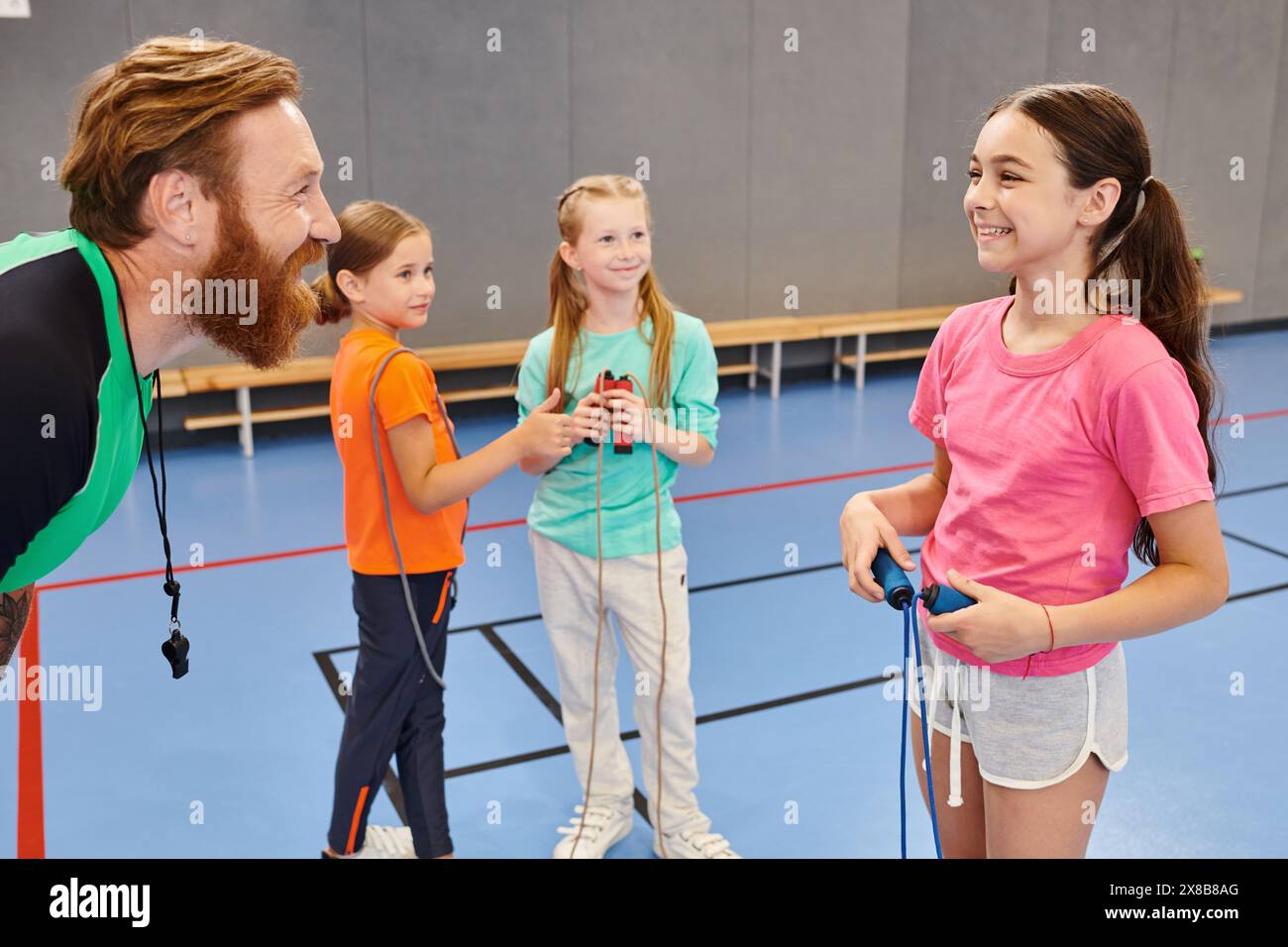 A bearded man enthusiastically teaches a group of diverse children in a ...