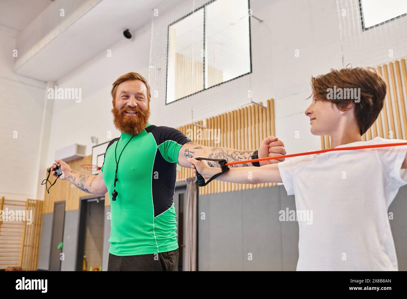 A jubilant teacher guides a young student through an exercise, in a ...