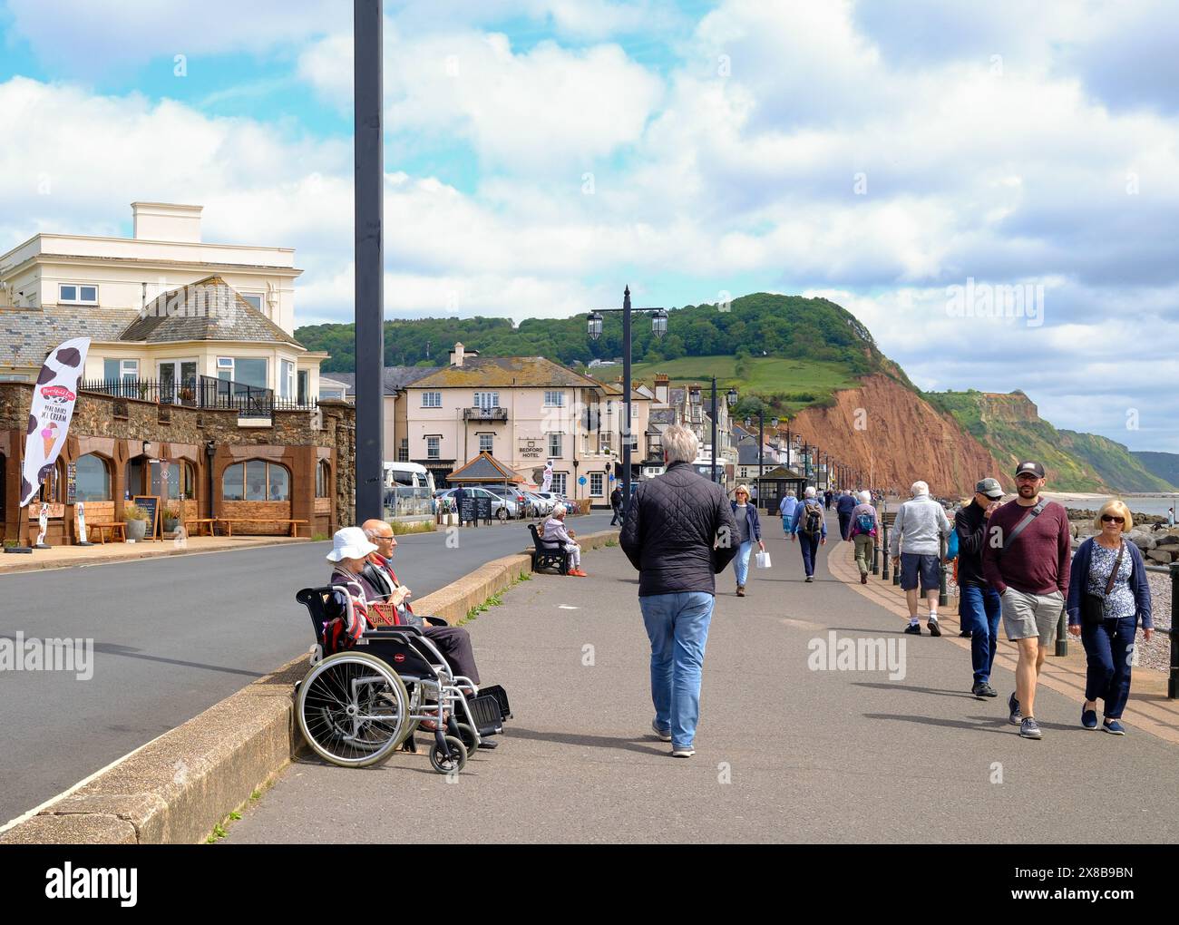 People enjoying walking on Sidmouth promenade on a late spring ...