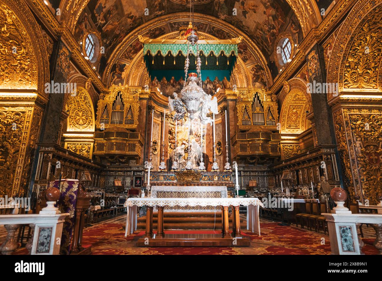 A view of the altar, pipe organ, and ornate gold details inside St ...