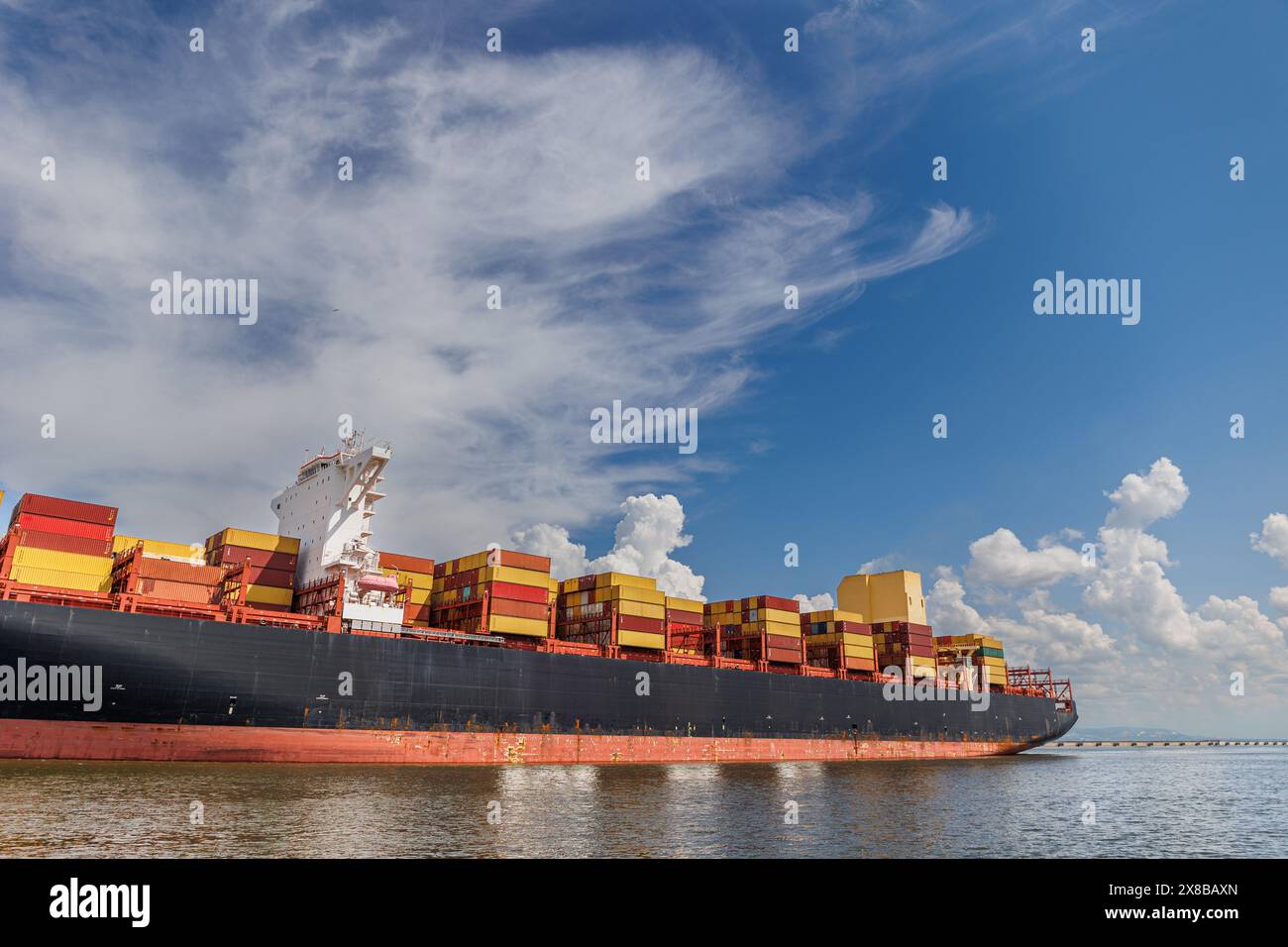 Container cargo ship in sea in blue sky background with copy space ...