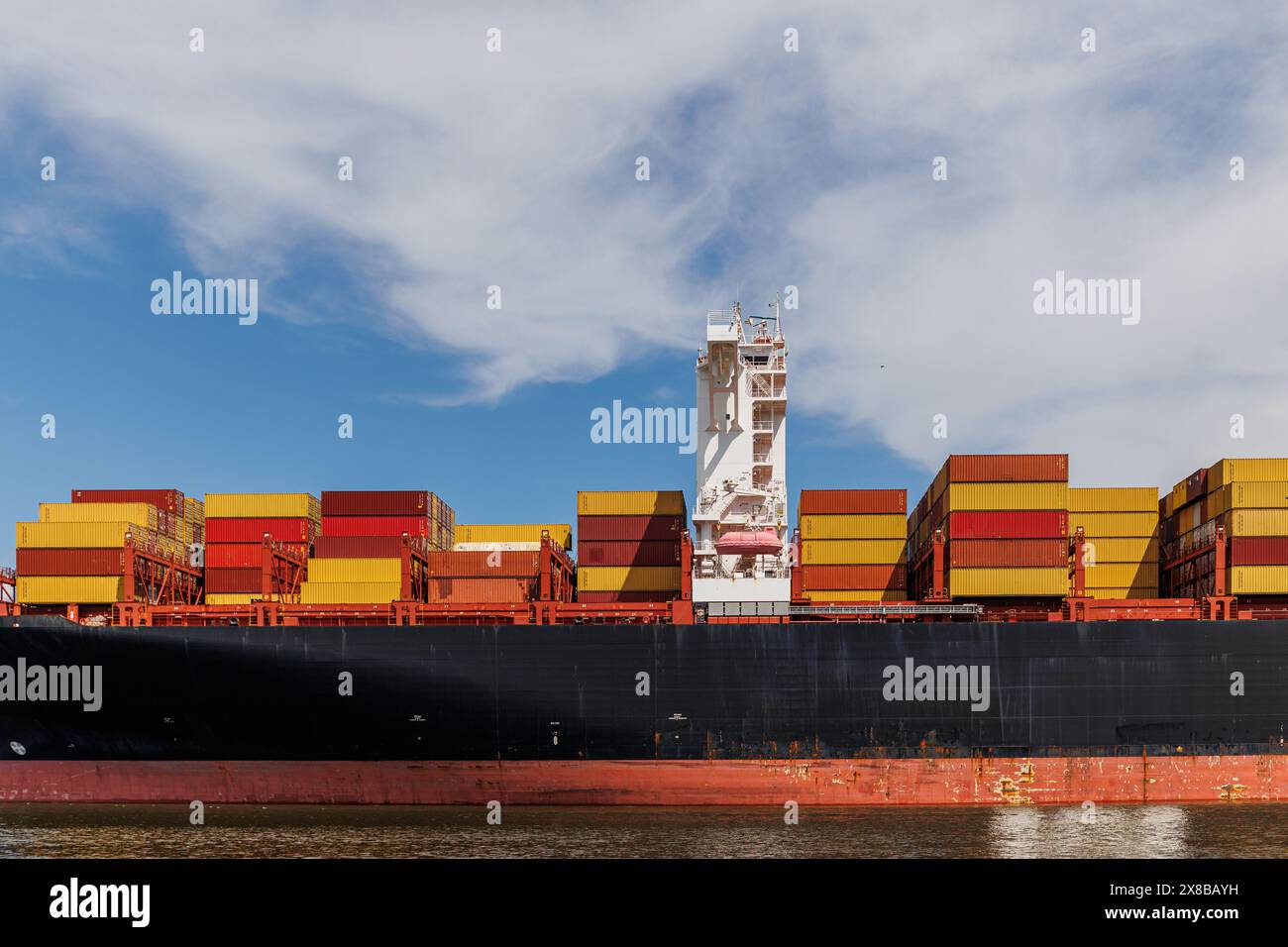 Container ship carrying container box in import export with quay crane ...