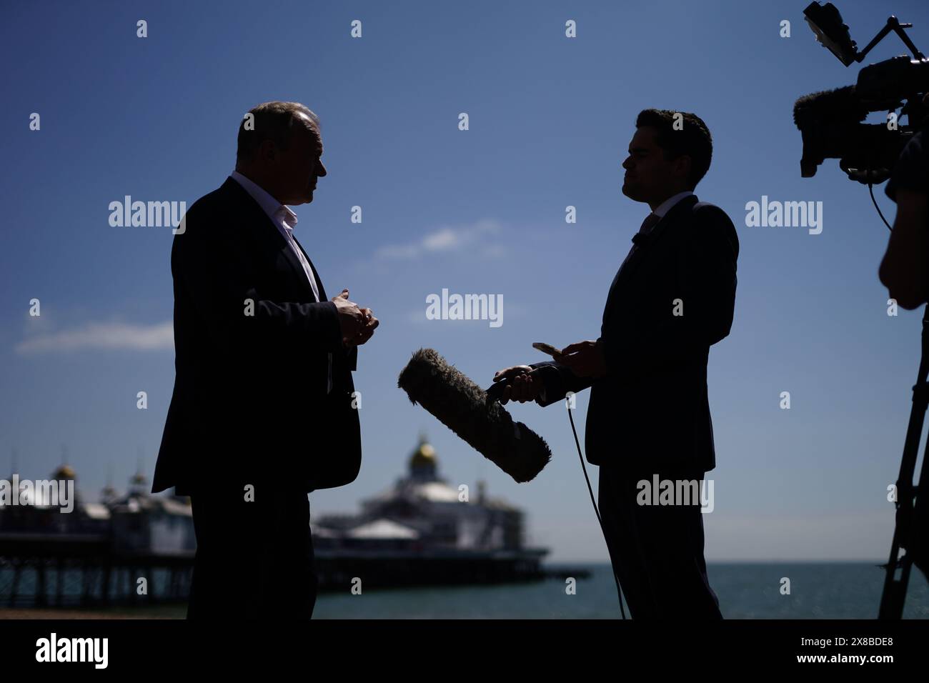Liberal Democrat leader Sir Ed Davey (left) speaks to the media on the ...