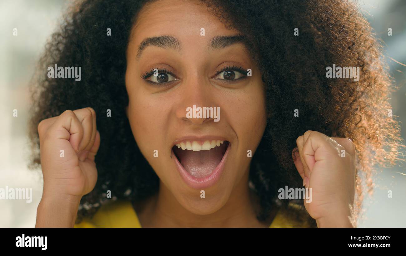 Close up happy excited African American woman celebrate winning ...
