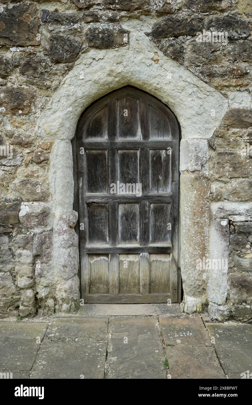 Ancient wooden door in a stone castle wall. England, UK Stock Photo - Alamy