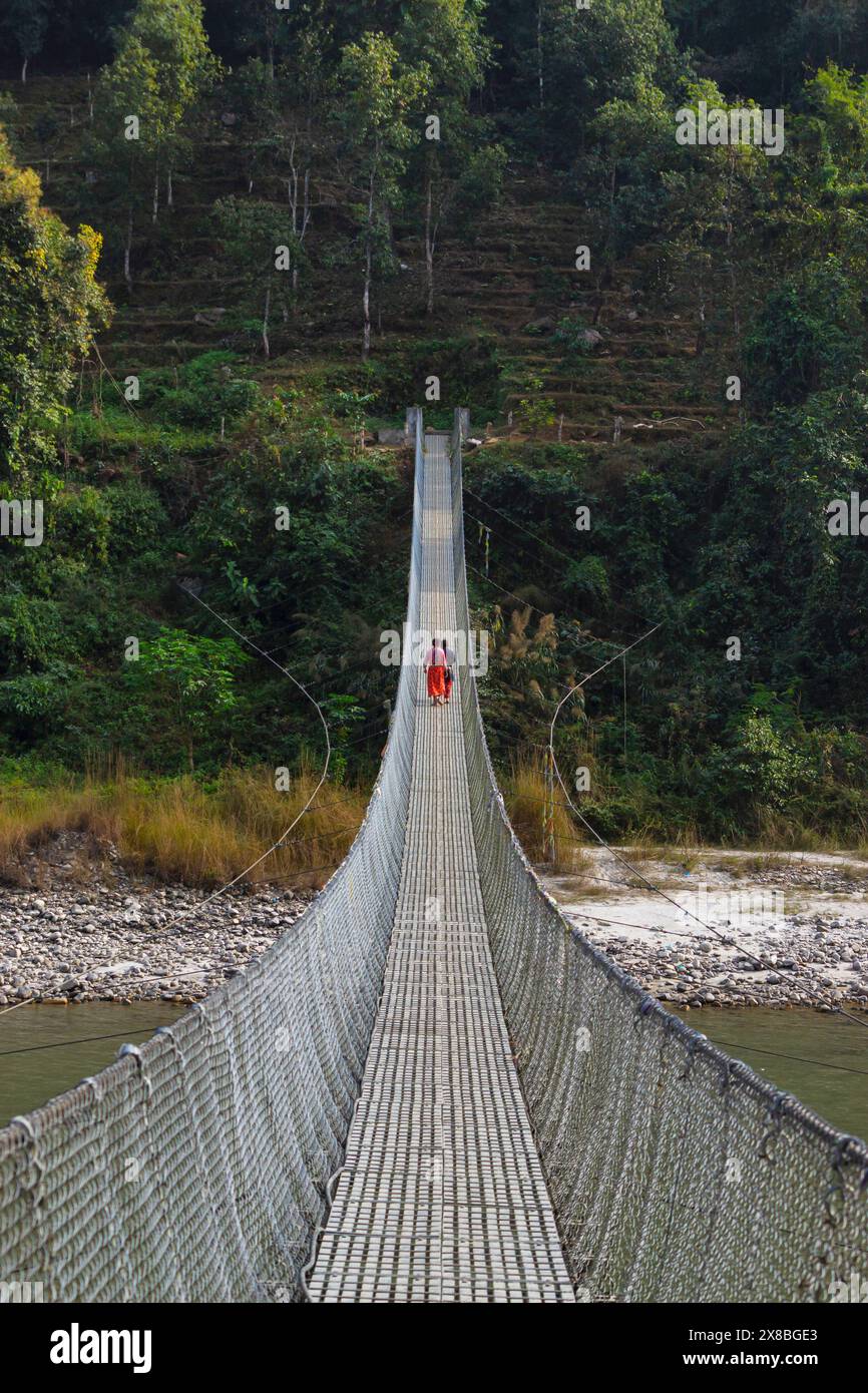NEPAL, December 2023, People at Hanging Bridge on Sunkoshi River, on ...