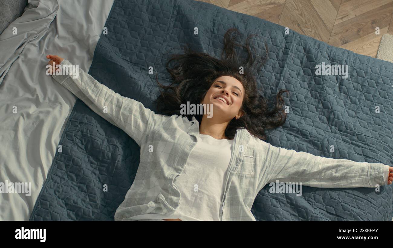 Top view Caucasian Young woman brunette fall on bed rest pleasure ...