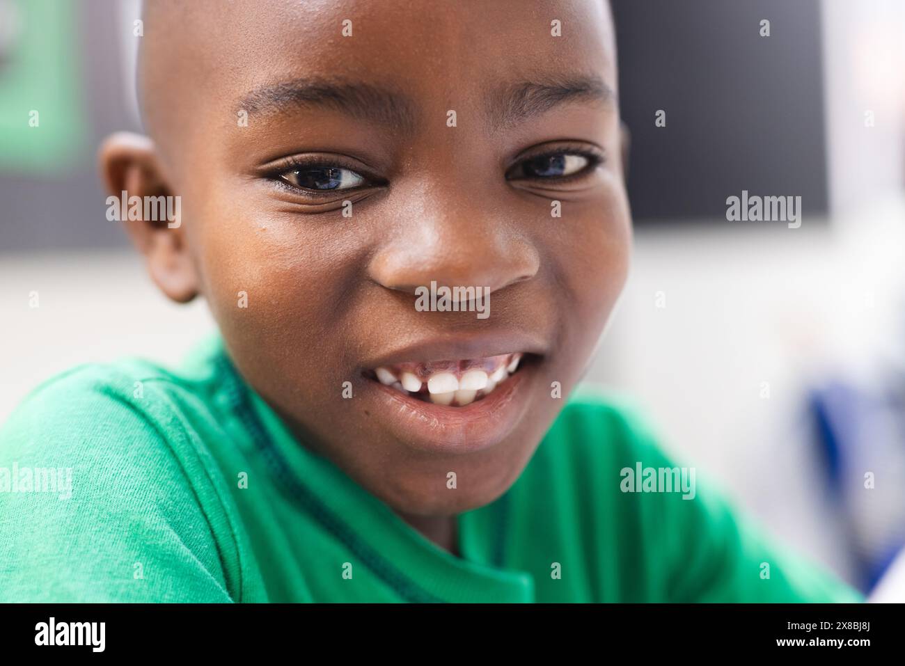 In school, young African American boy is smiling at camera in the ...