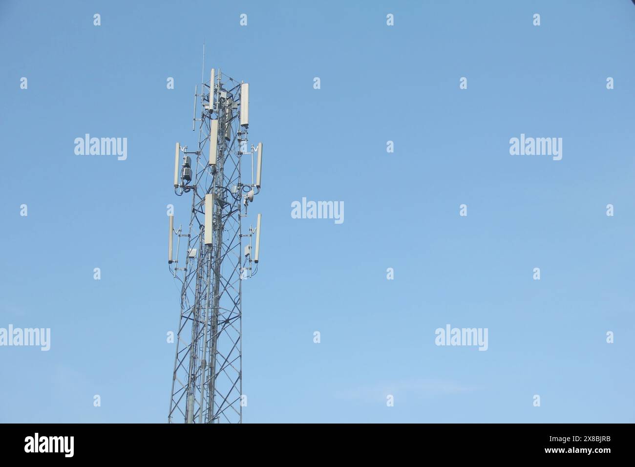 Telecommunications tower standing tall against a bright blue sky ...