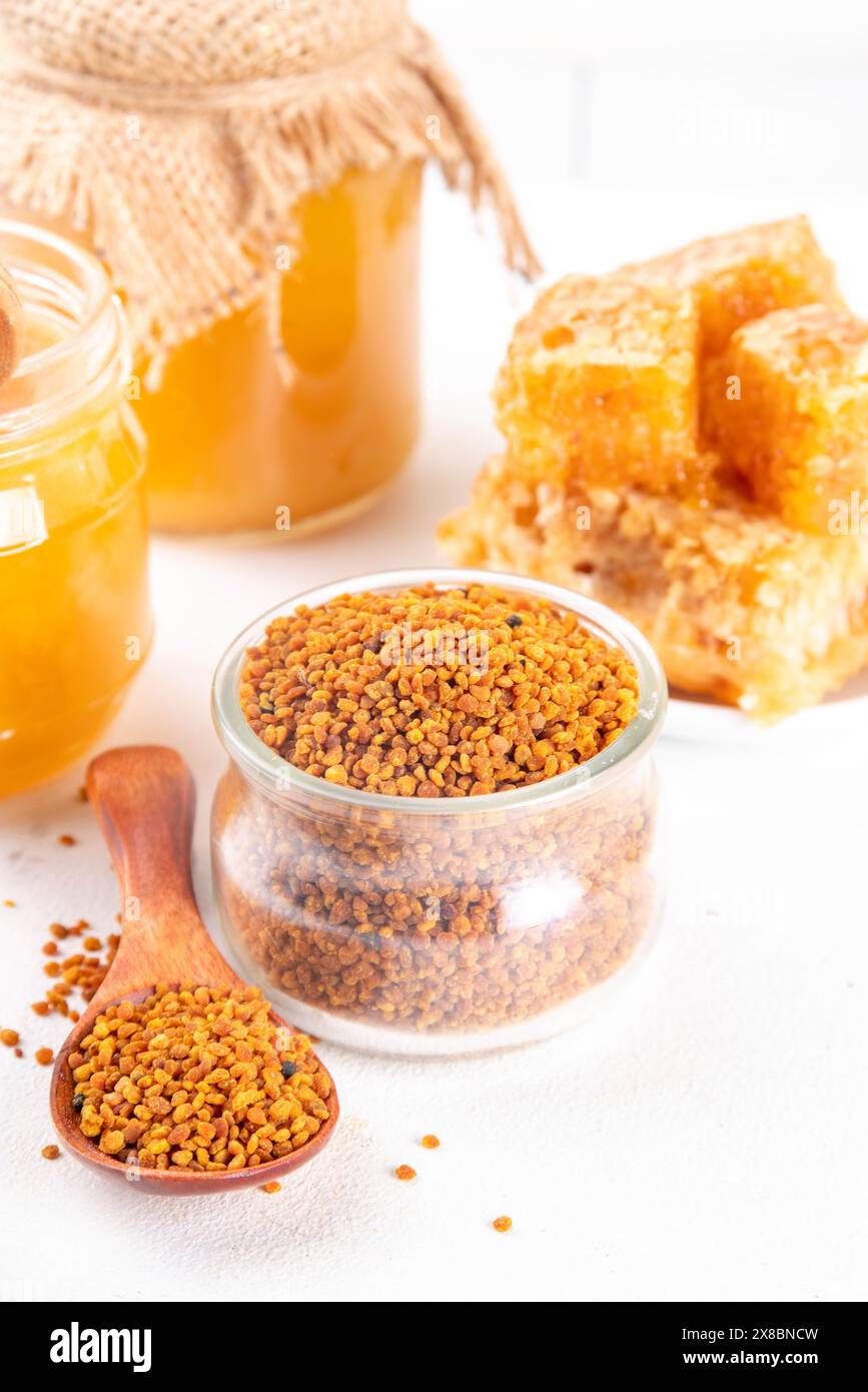 Bee pollen jar and spoon with honey and honeycomb. Trendy superfood ...