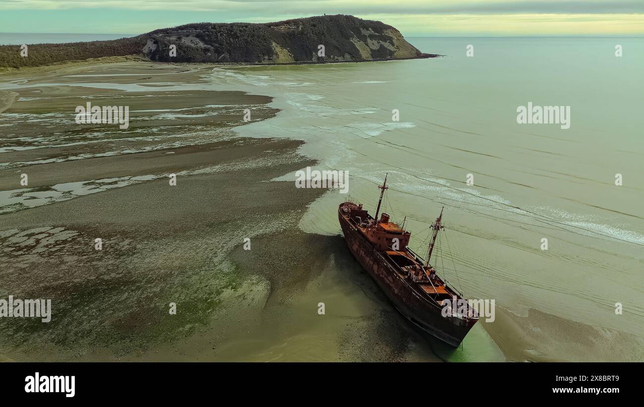 Aerial view of a ship aground and rusty on the coast of Cabo San Pablo ...