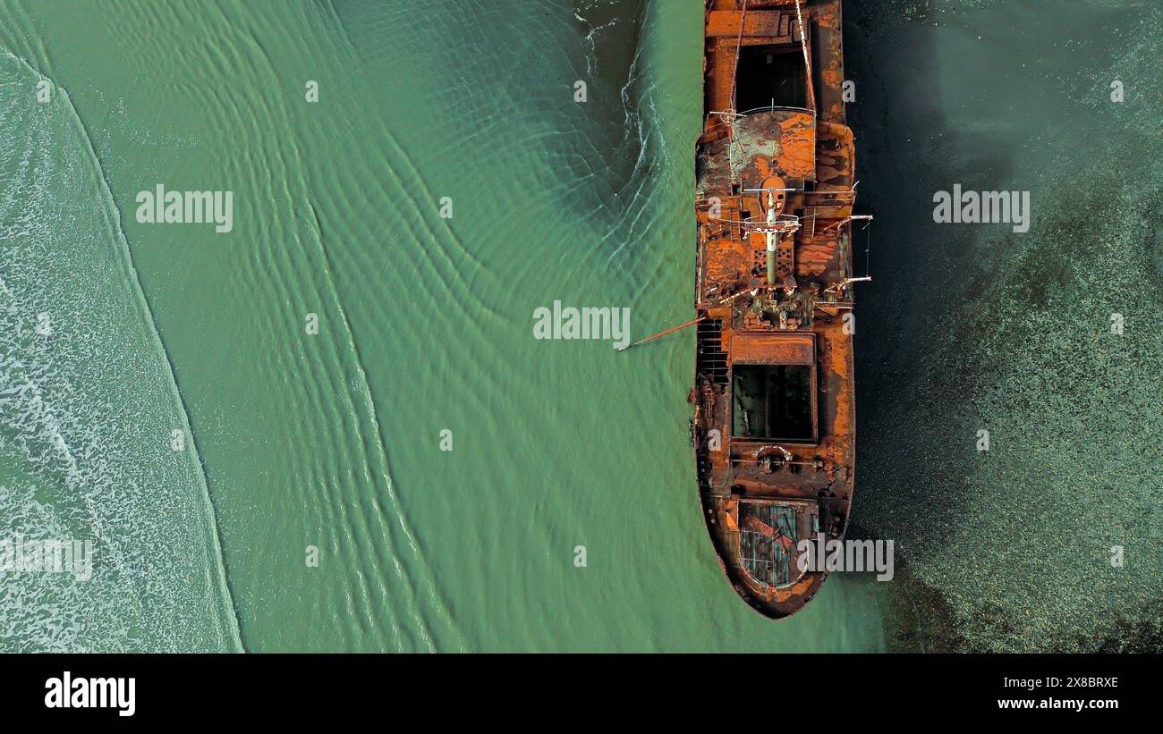 Aerial view of a ship aground and rusty on the coast of Cabo San Pablo ...