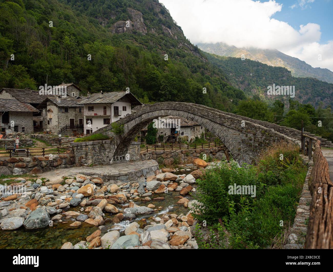 Old medieval stone bridge in the small mountain village of Fondo in ...