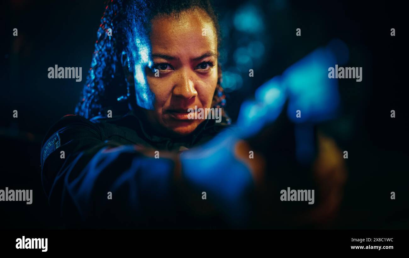 Portrait of Black Female Police Officer Aiming Gun at Criminal, Orders ...