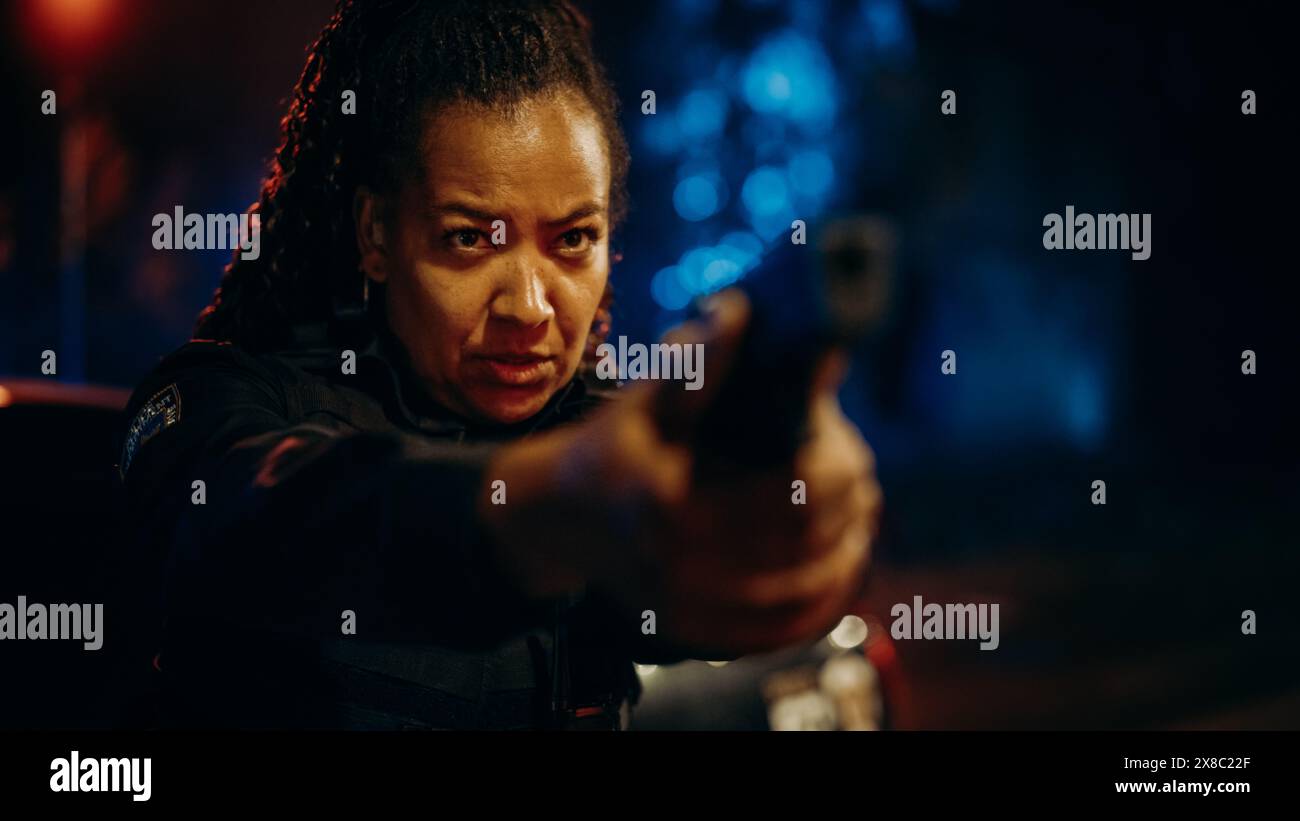 Portrait of Black Female Police Officer Aiming Gun at Criminal, Orders ...