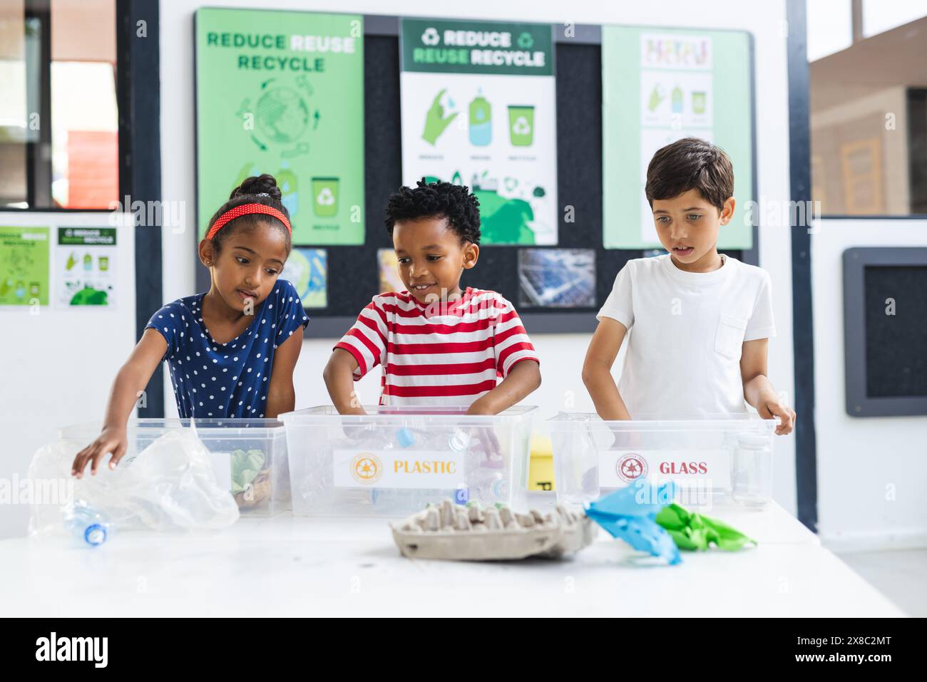 In school, diverse young students sorting recycling materials in the ...