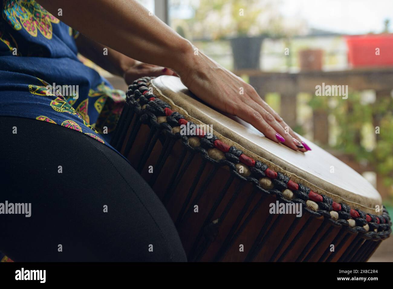 Closeup of Female Hands on the leather head of a Djembe drum of a ...