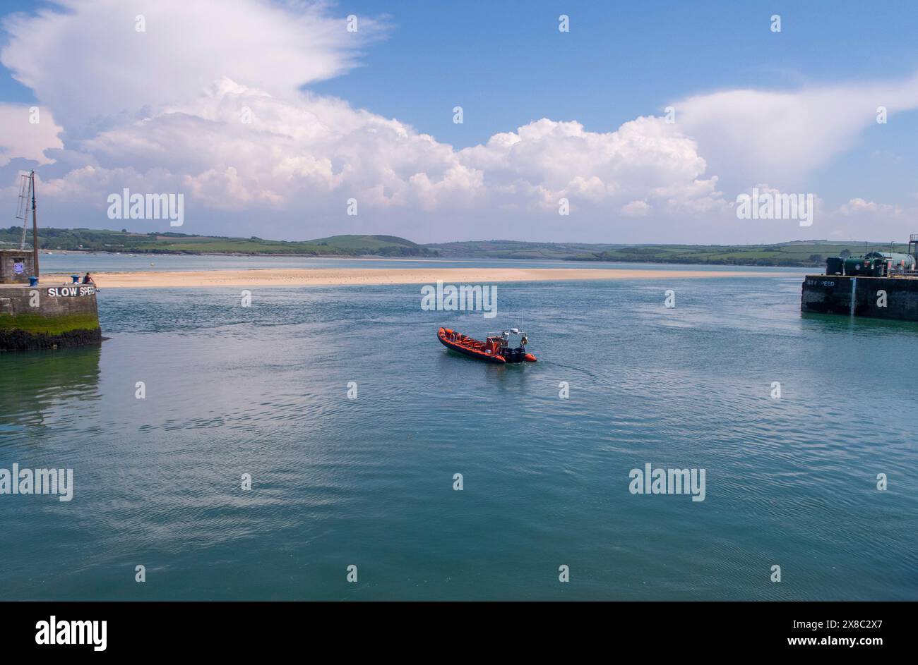 A boat heads out of Padstow harbour into the river Camel at Padstow ...
