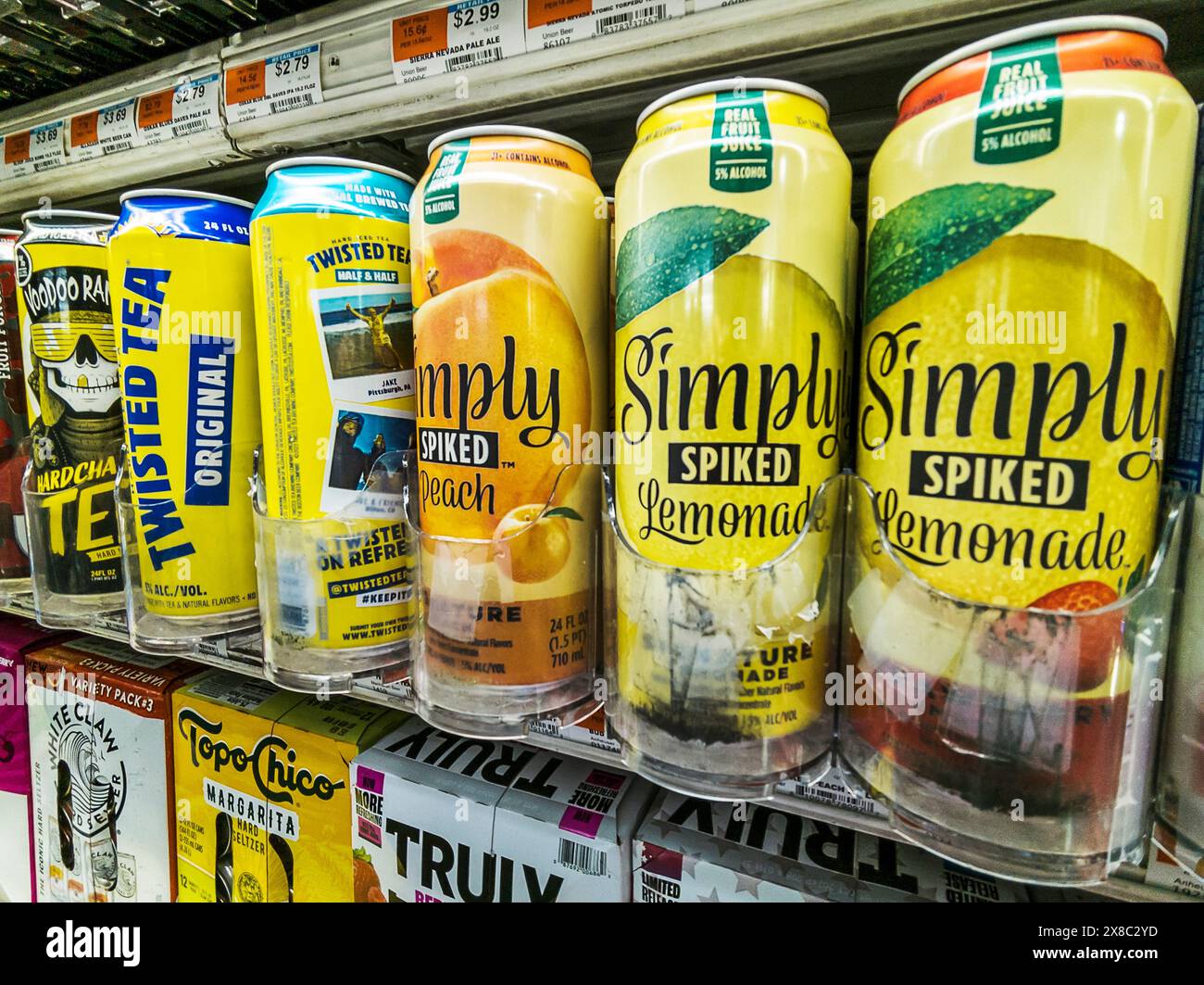 Cans of Simply Spiked Lemonade in various flavors in a cooler in a ...