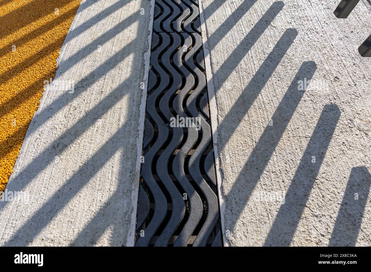 Late afternoon image of an ornamental metal trench drain in concrete ...