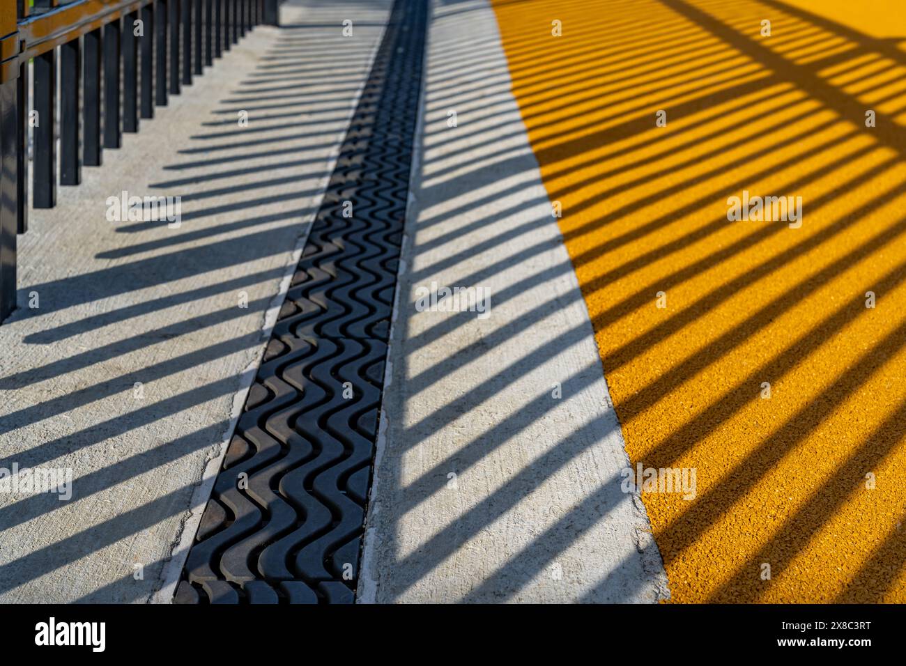 Late afternoon image of an ornamental metal trench drain in concrete ...
