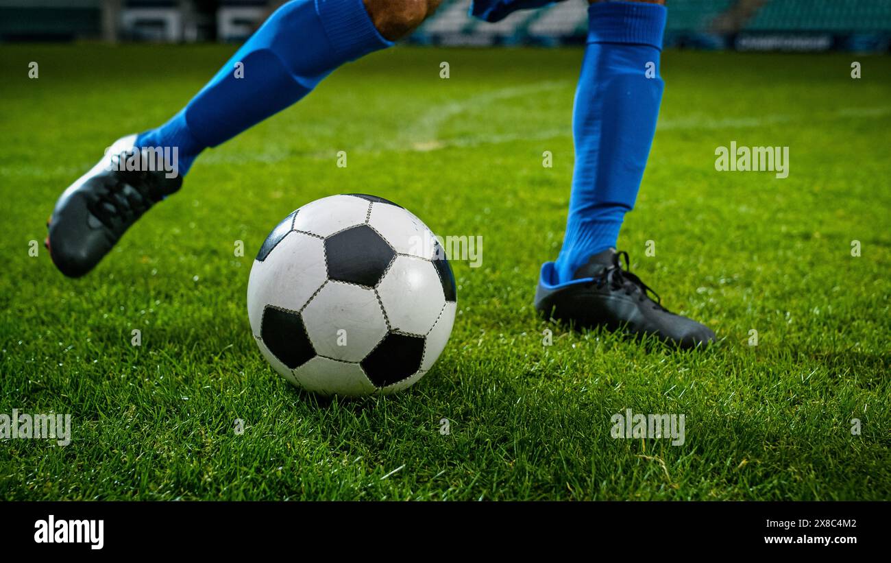 Close-up of a Leg in a Boot Kicking Football Ball. Professional Soccer ...