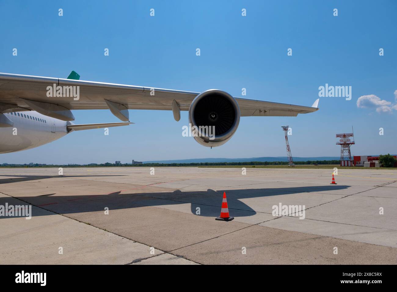 The airfoils and jet engine of an airplane. The plane is on the runway ...