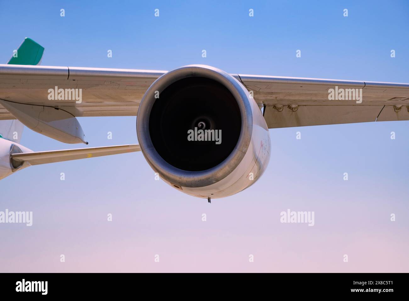 The jet engine of an airplane is on. These gas turbines are huge and ...