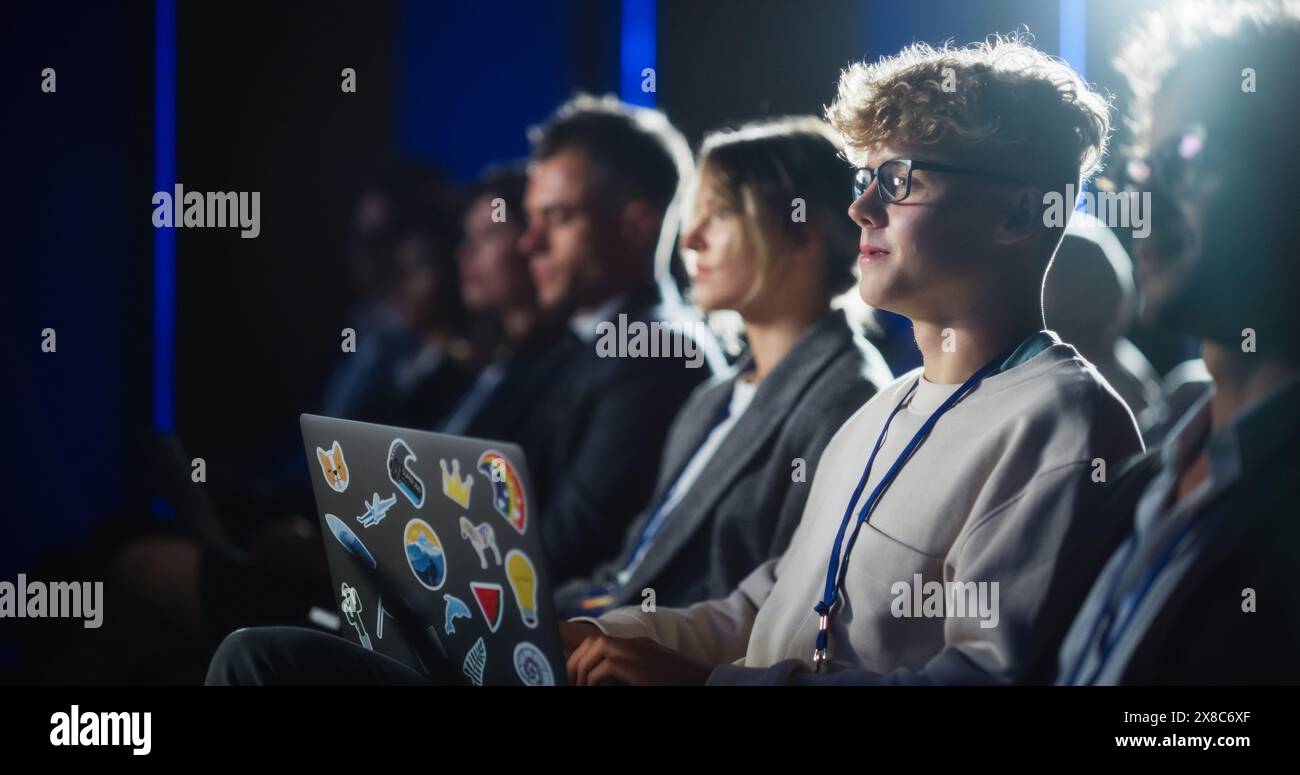 Young Handsome Man Sitting in a Crowded Audience at an International ...