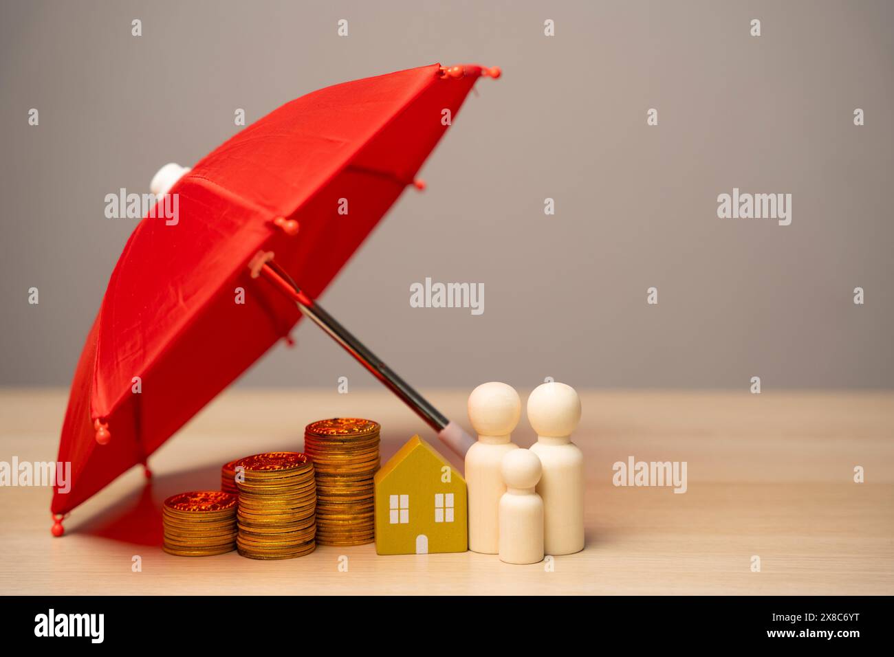 Property and family insurance concept. Miniature figures of a family ...