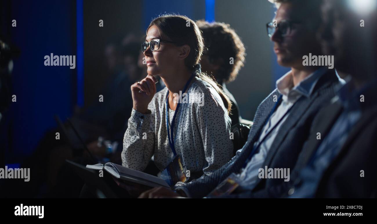 Young Enthusiastic Female Attending a Motivational Speaker Event, Sitting in a Crowded Concert ...