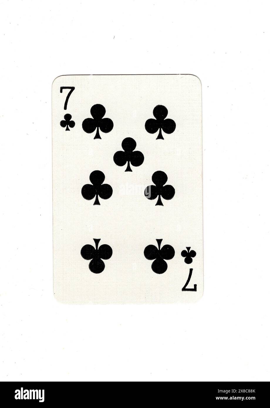 A vintage seven of clubs playing card isolated on a white background ...