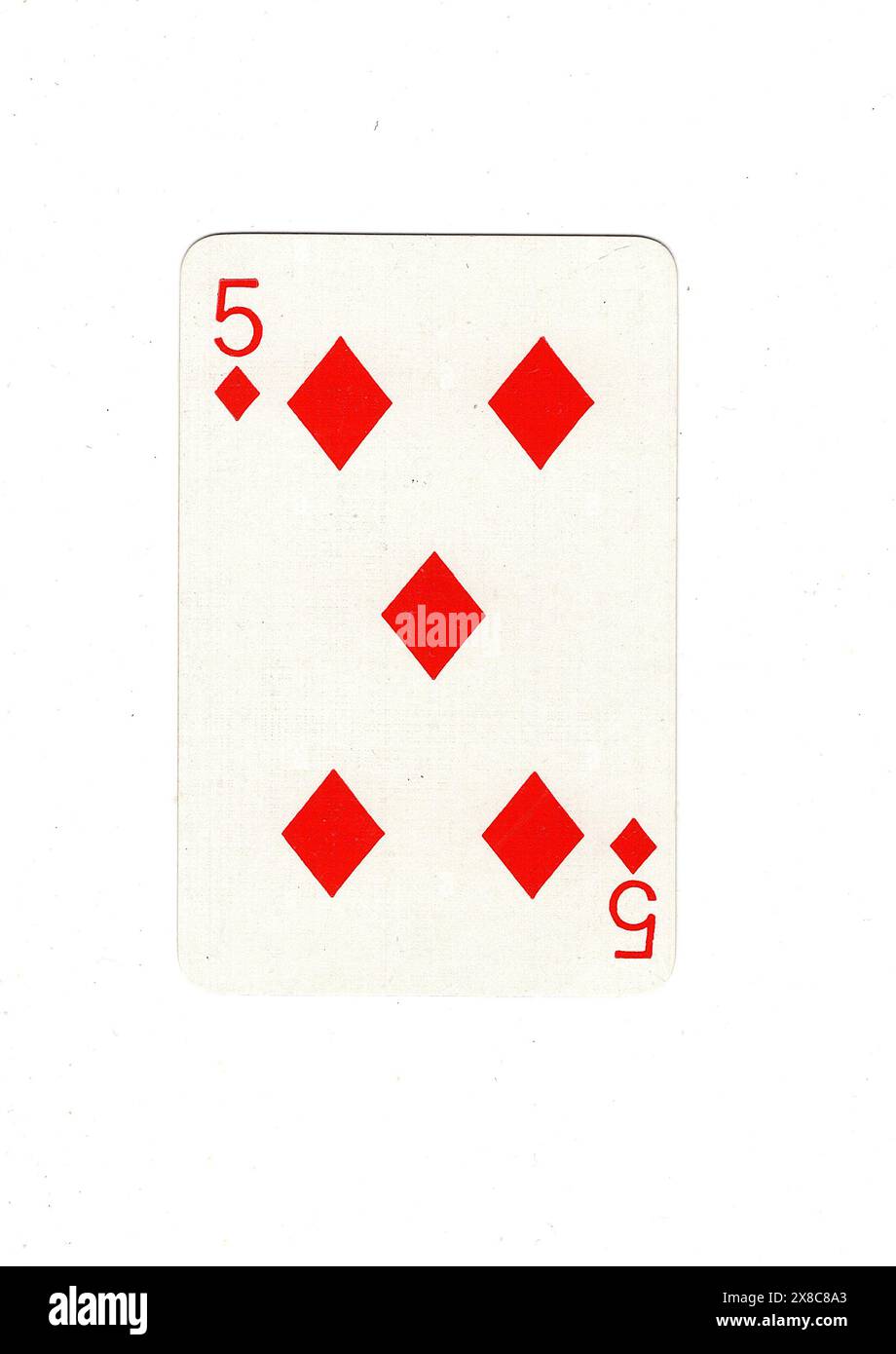 A vintage five of diamonds playing card isolated on a white background ...