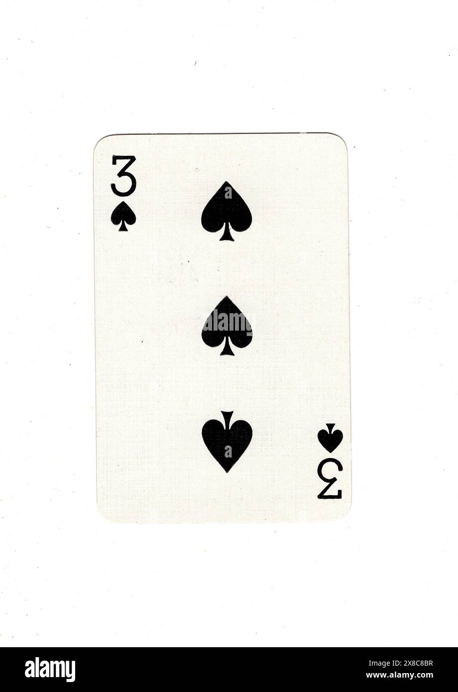 A vintage three of spades playing card isolated on a white background ...