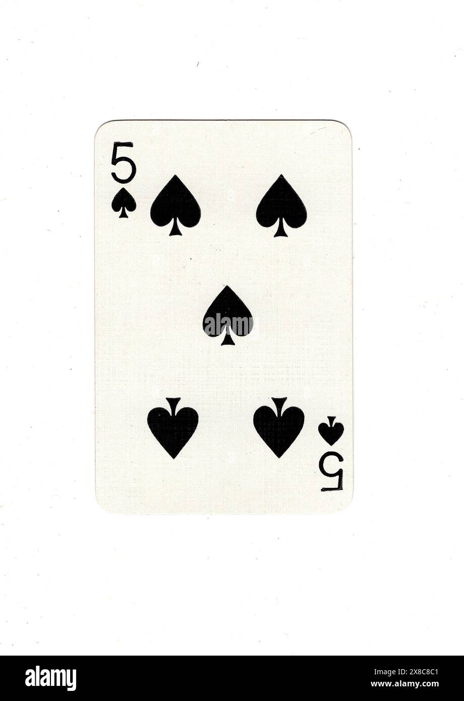A vintage five of spades playing card isolated on a white background ...