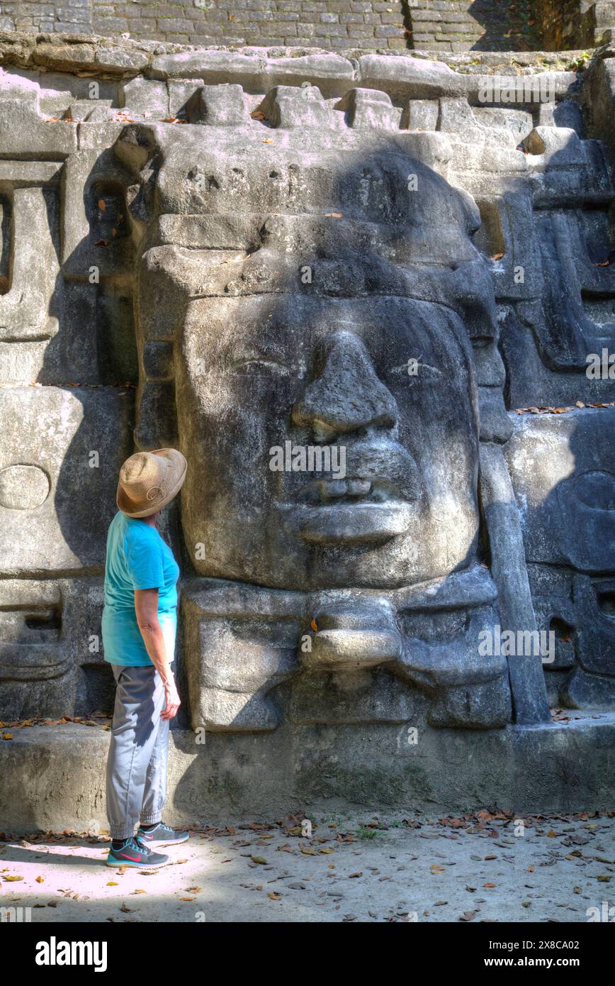 Tourist looking on, Stucco Mask, The Mask Temple, Lamanai Mayan Site ...