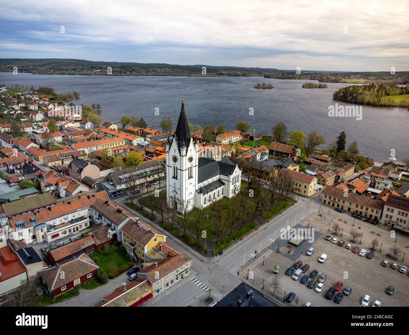 Aerial view of a picturesque town with a central church and tall spire ...