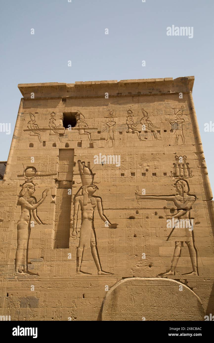 Reliefs of the Goddess Hathor (left) and the God Horus (center) with Neos Dionysos (right ...