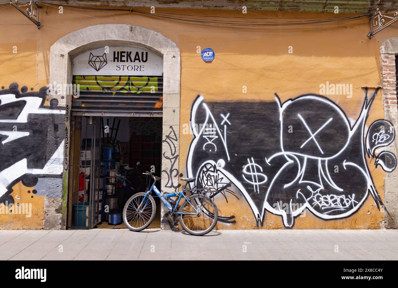 Mexico City graffiti on a wall, and a bicycle outside a store, mexico ...