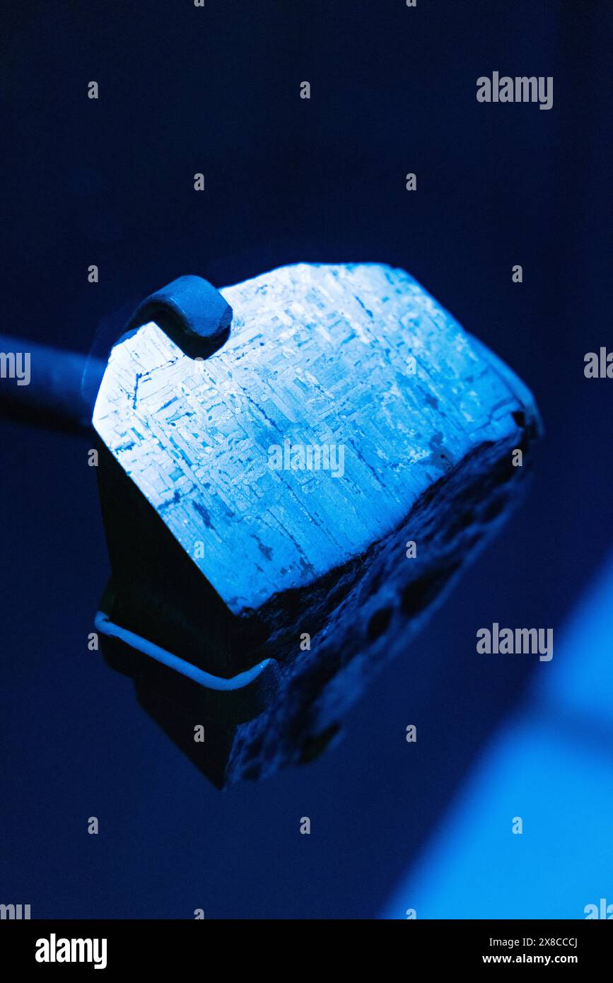 Iron meteorite - close up of the polished surface under blue light ...