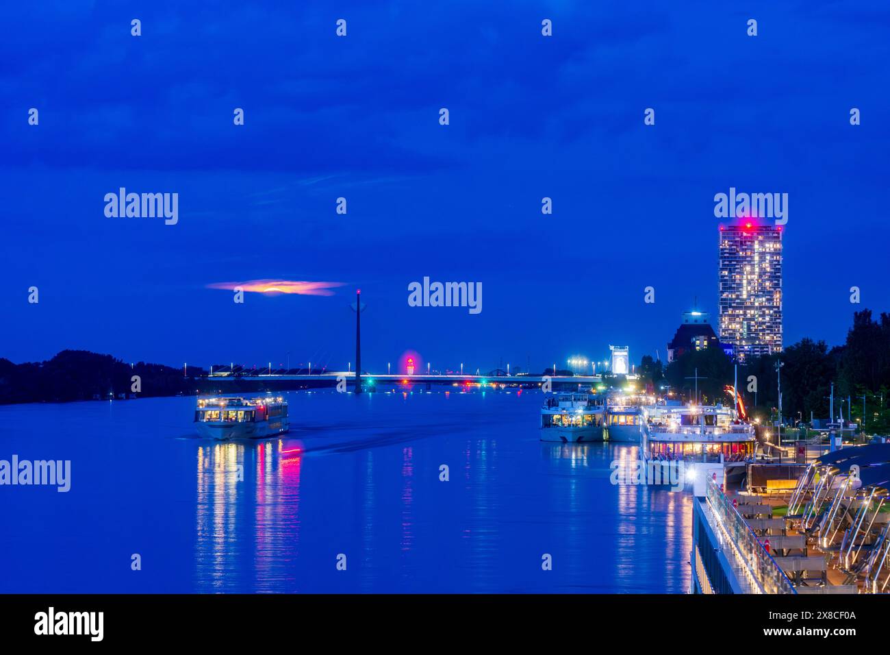 Vienna: full moon above river Donau (Danube), cruise ship, bridge ...