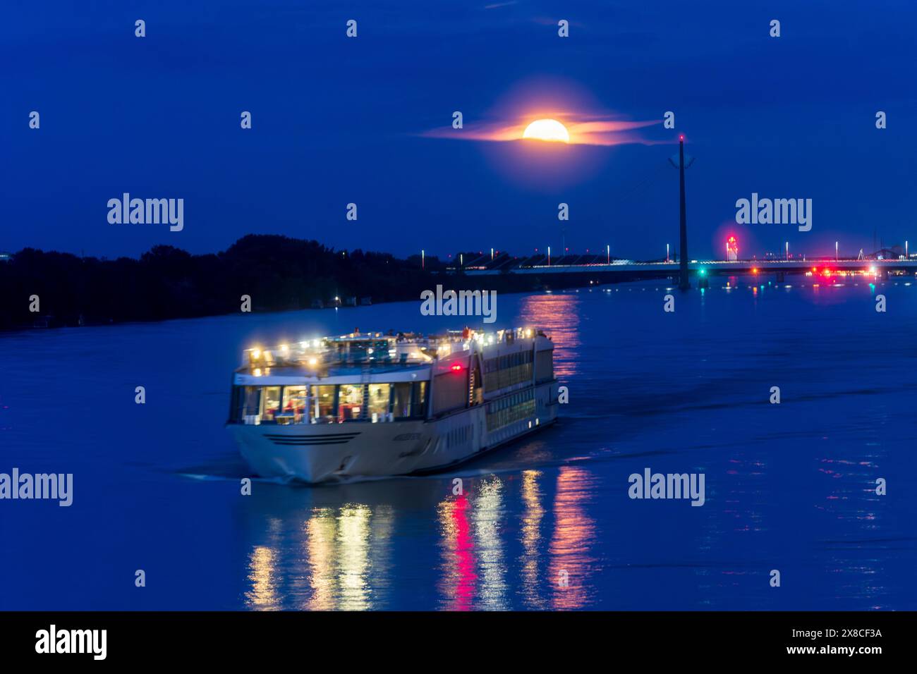 Vienna: full moon above river Donau (Danube), cruise ship, bridge ...