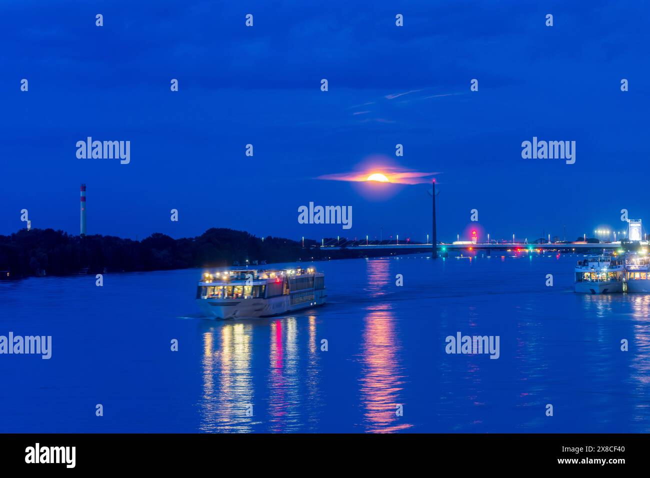 Vienna: full moon above river Donau (Danube), cruise ship, bridge ...