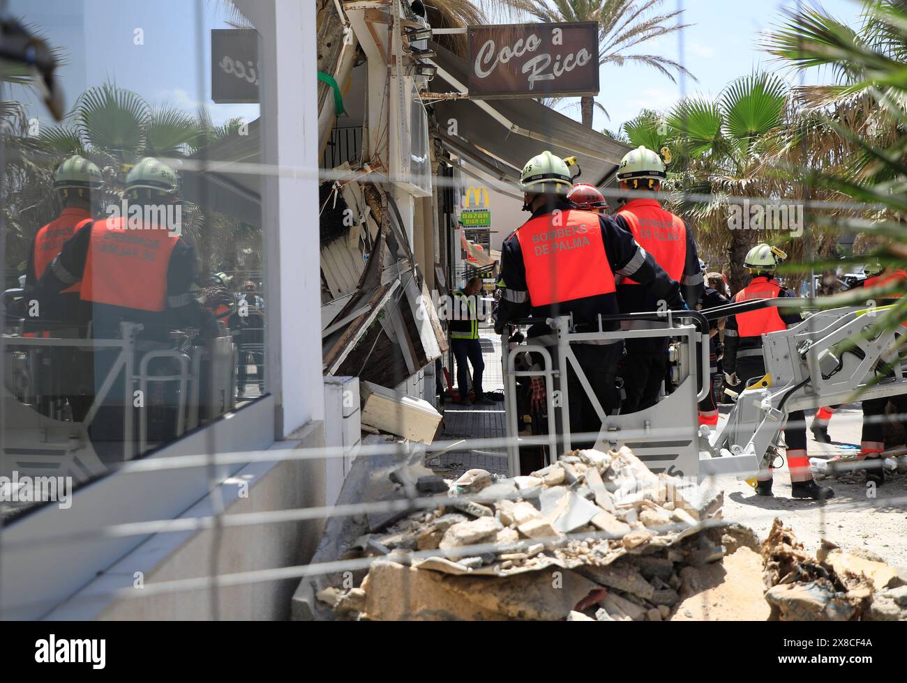 24 May 2024, Spain, Palma: Firefighters work on the Medusa Beach Club ...