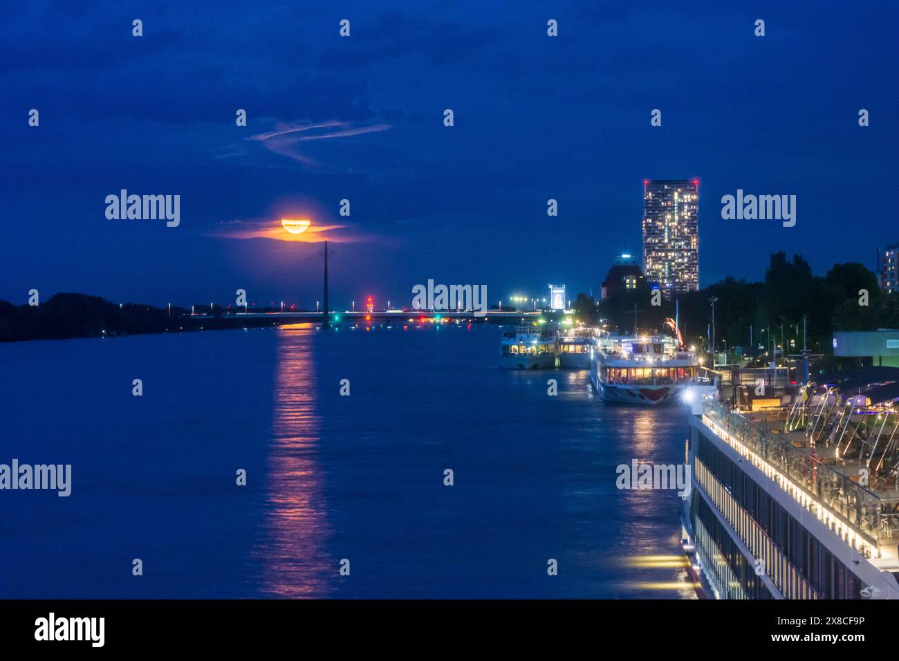 Vienna: full moon above river Donau (Danube), cruise ship, bridge ...