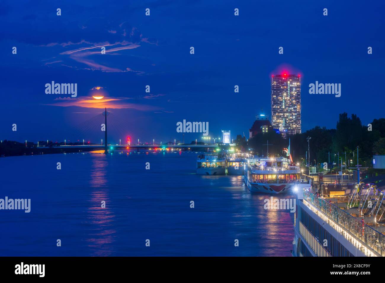 Vienna: full moon above river Donau (Danube), cruise ship, bridge ...