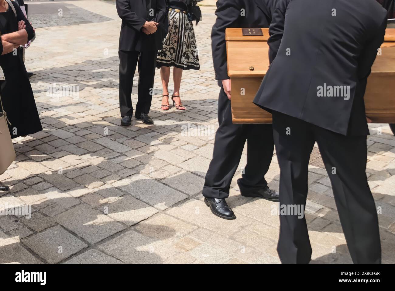 Men of funeral service loading the coffin into the hearse Stock Photo ...